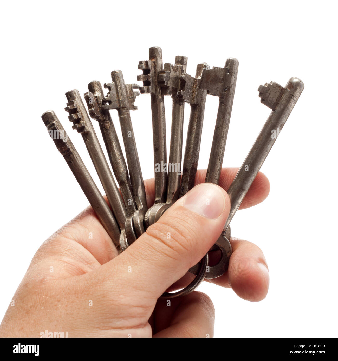Old rusty bunch of keys in hand. Isolated on white Stock Photo - Alamy