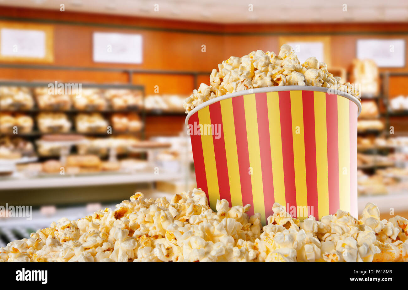 Shot of popcorn in large bucket against shop interior Stock Photo - Alamy