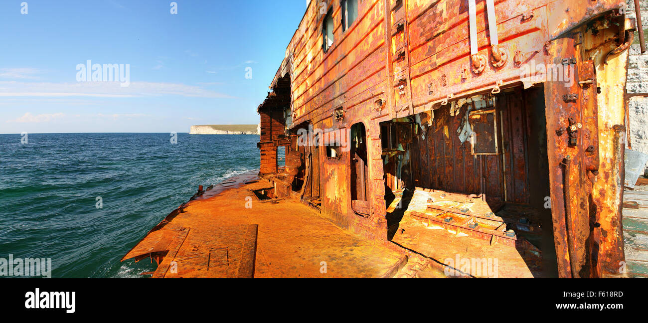 Shipwreck. Rusty cargo ship near mountain coast Stock Photo - Alamy
