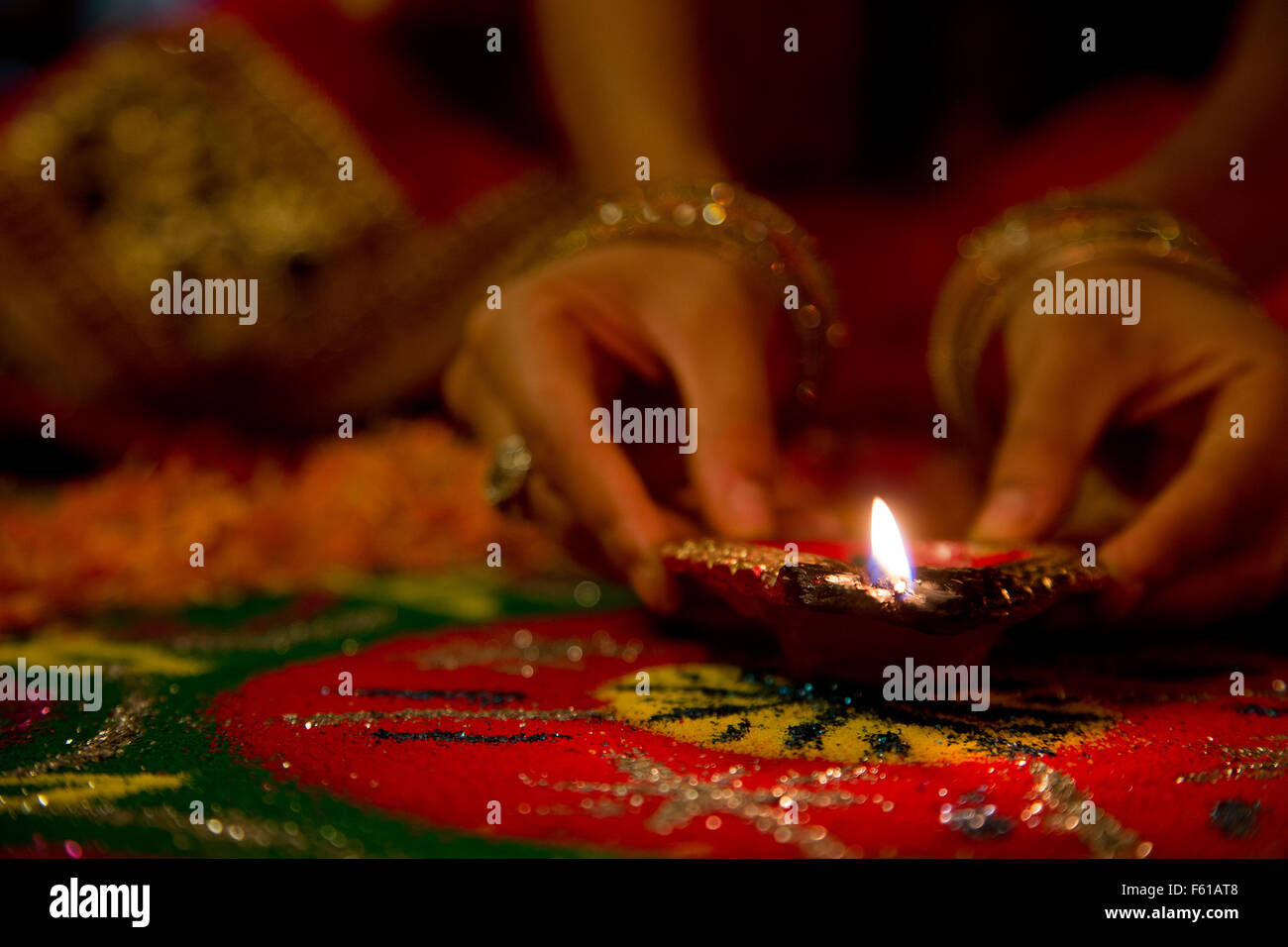 Indian woman making Rangoli during Diwali festival of India Stock Photo ...
