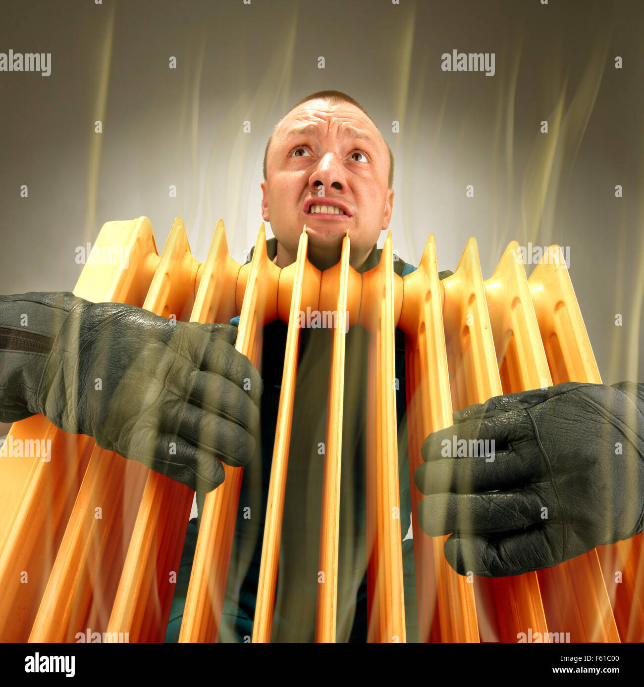 Bizarre freezing man holding hot oil radiator Stock Photo - Alamy
