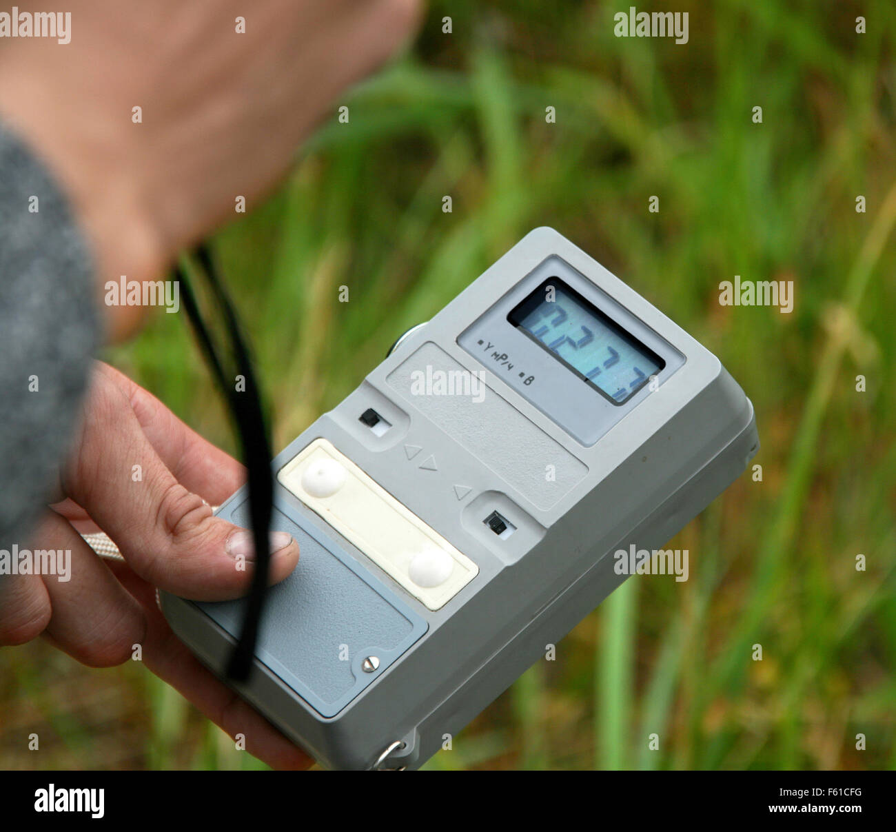 Worker measuring environmental radiation level by dosimeter Stock Photo ...