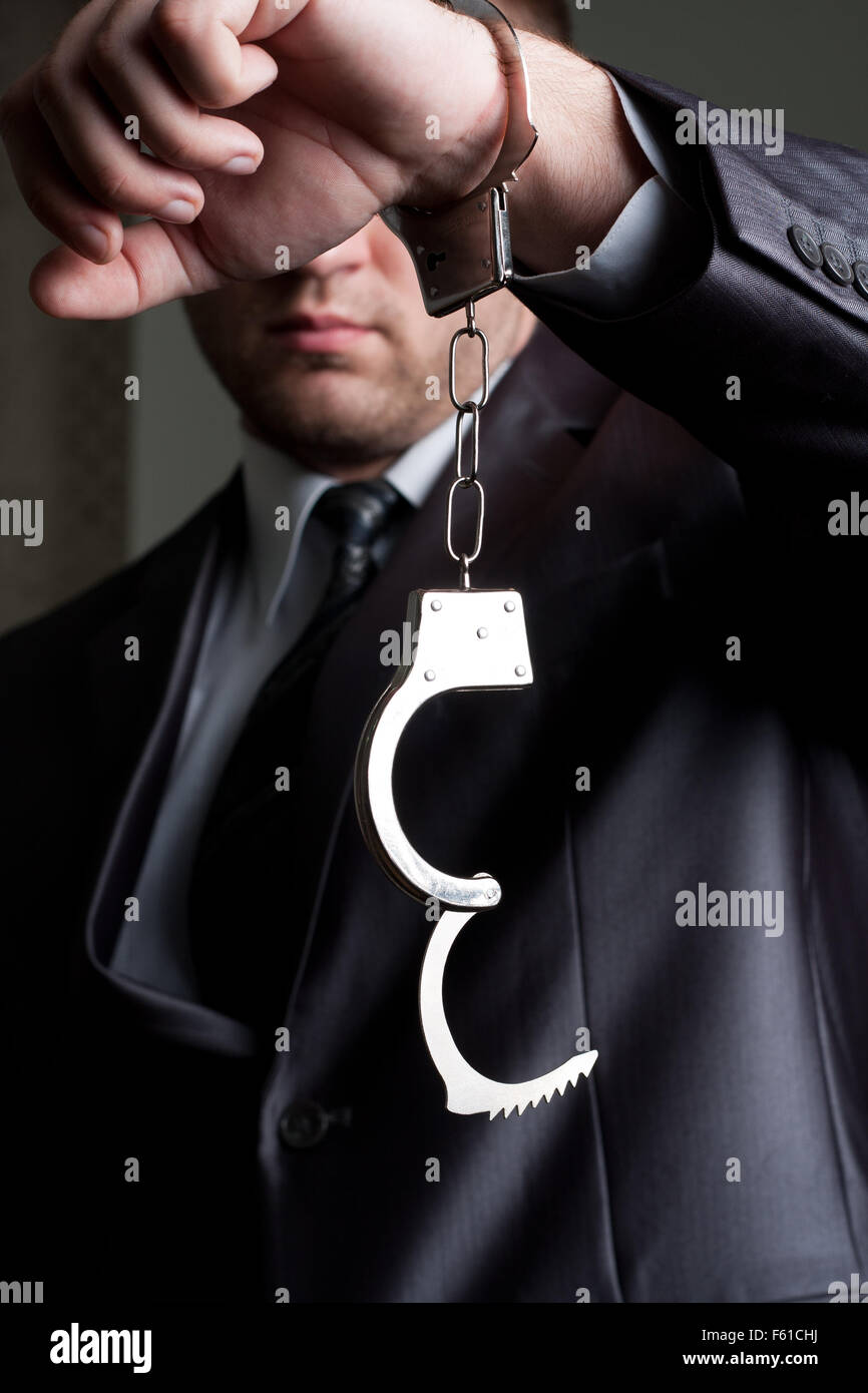 Freedom - businessman with unlocked handcuffs on hand Stock Photo - Alamy