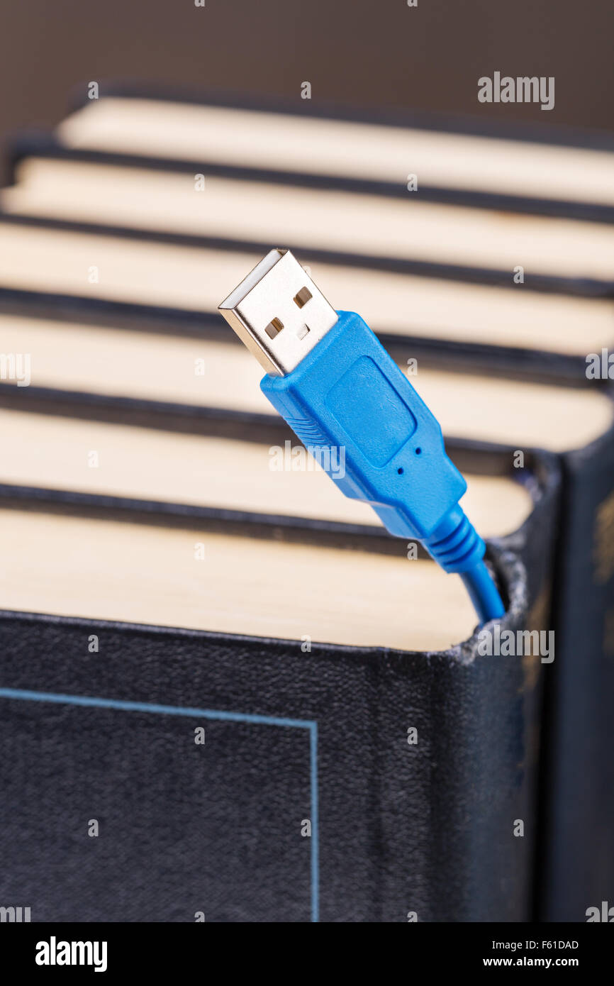 Blue usb cable sticks out from the books Stock Photo - Alamy