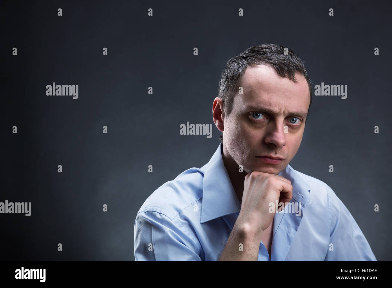 Pensive man thinking over gray background Stock Photo - Alamy
