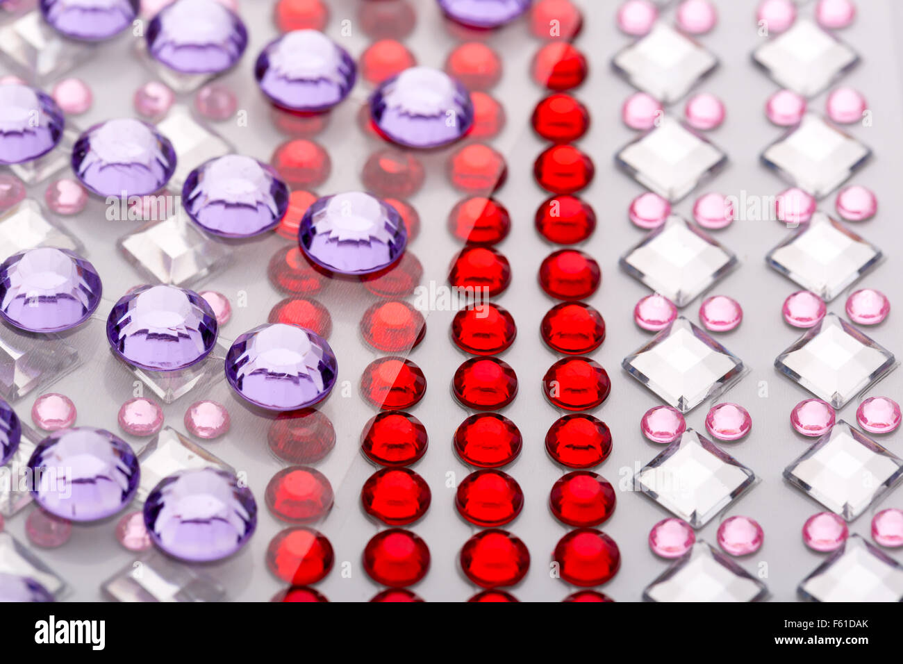 Various decorative gems in a row closeup Stock Photo - Alamy