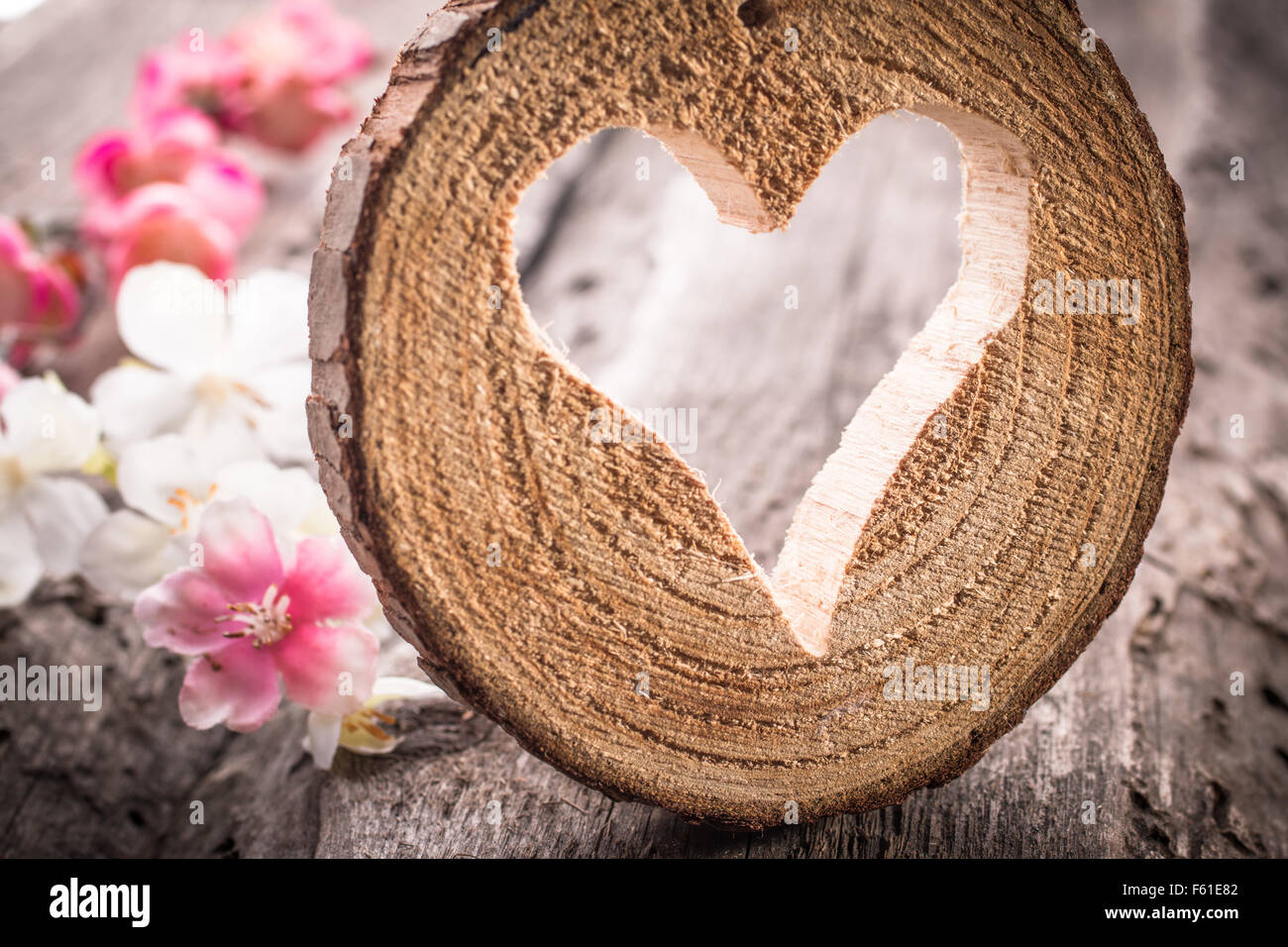 Light heart on rustic wooden background Stock Photo - Alamy