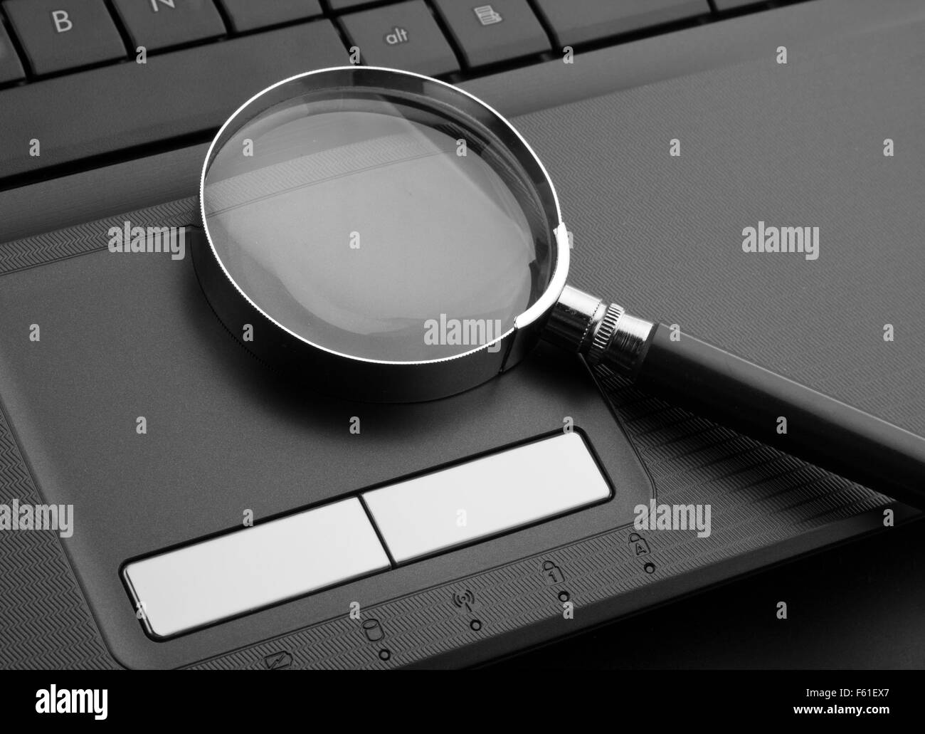 Magnifying glass on laptop computer Stock Photo - Alamy