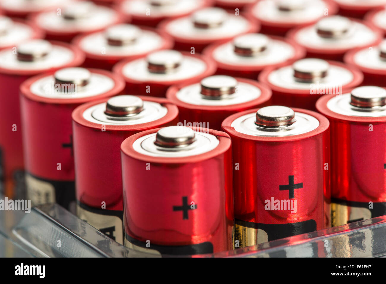Many red AA batteries in a row Stock Photo - Alamy