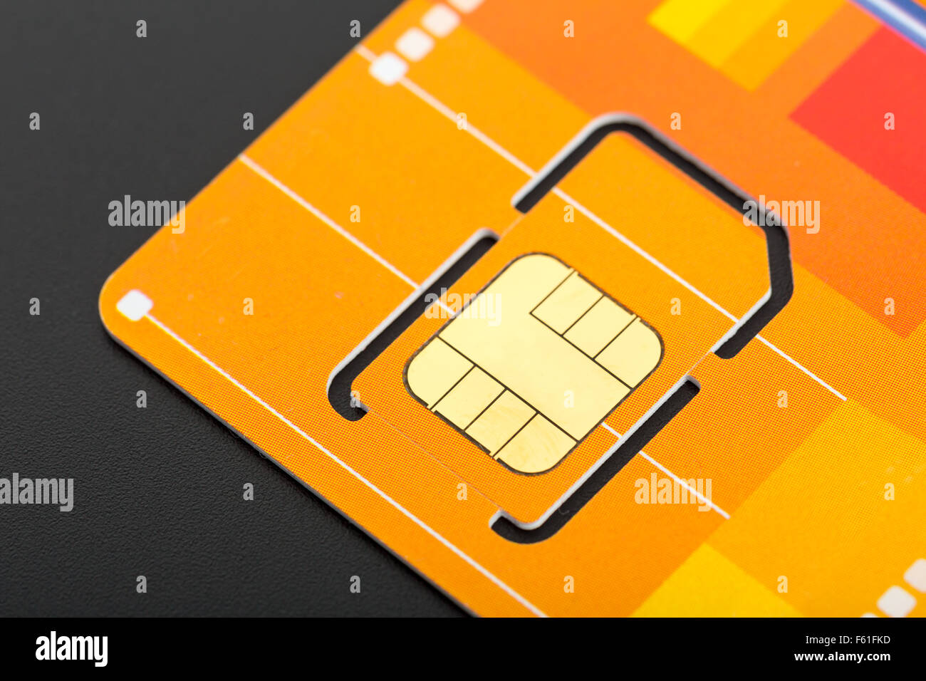 Yellow sim card on grey background Stock Photo - Alamy