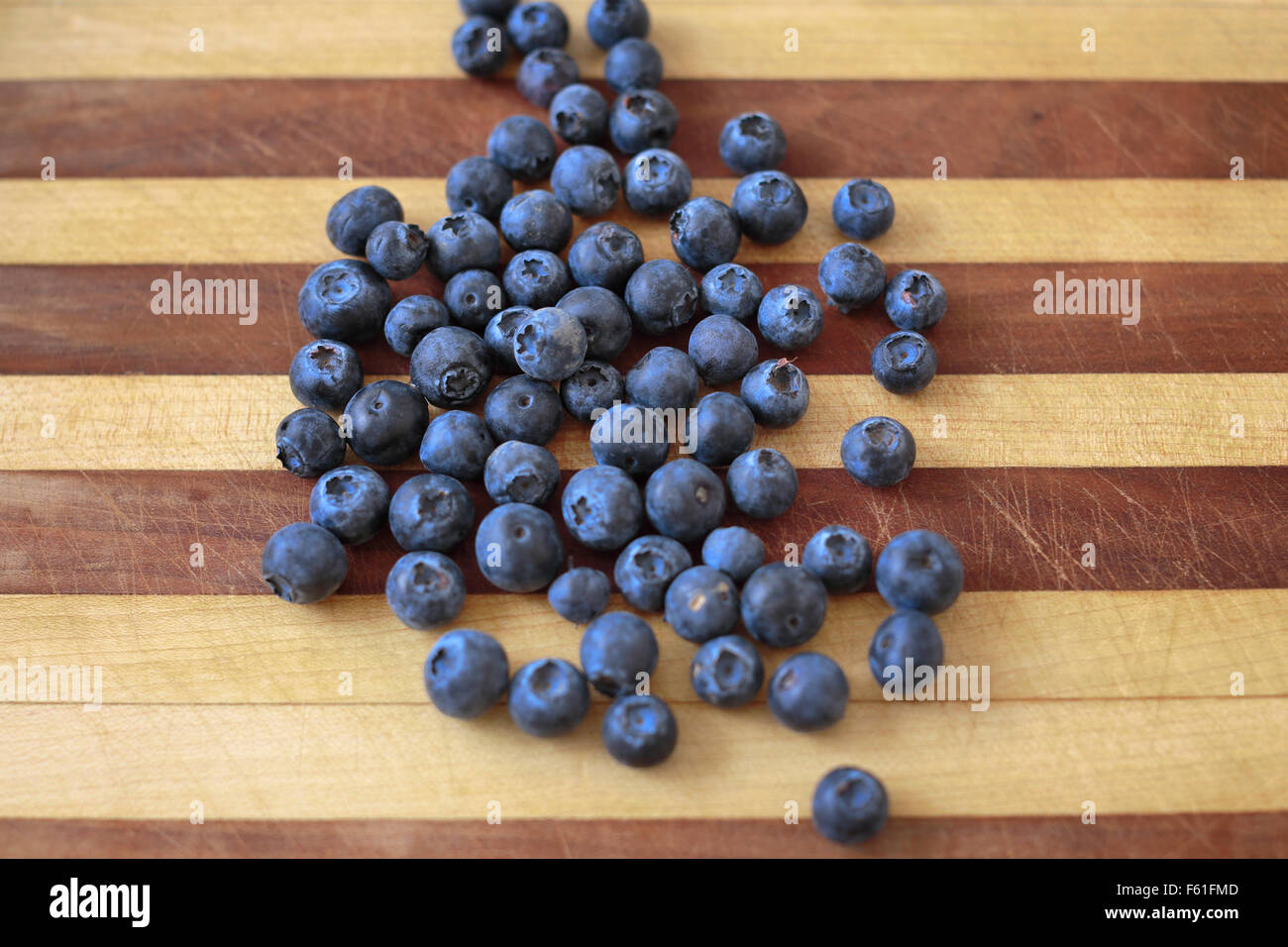 A bunch of blueberries on a cutting board ready to become part of a ...