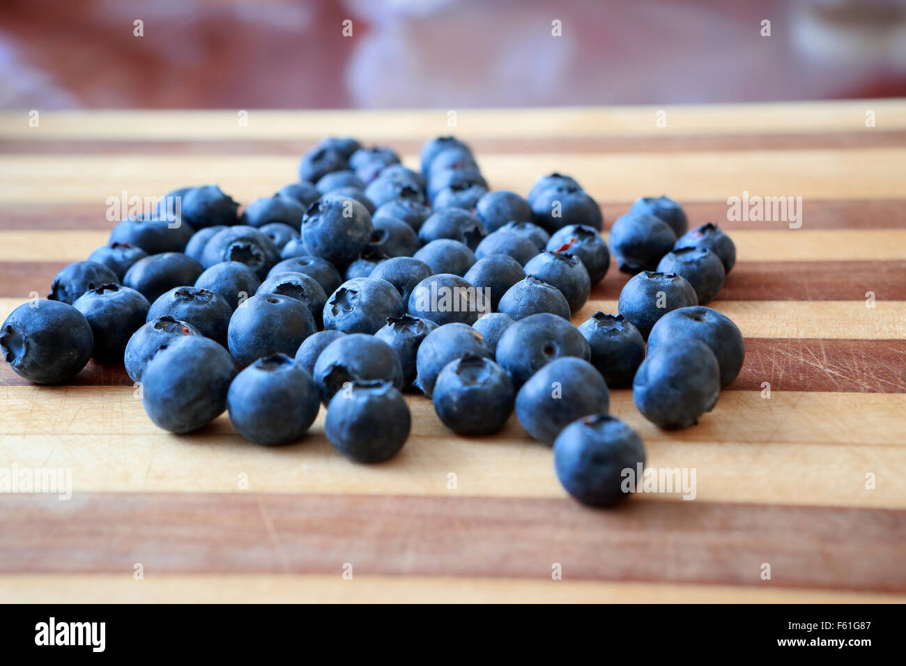 A bunch of blueberries on a cutting board ready to become part of a ...