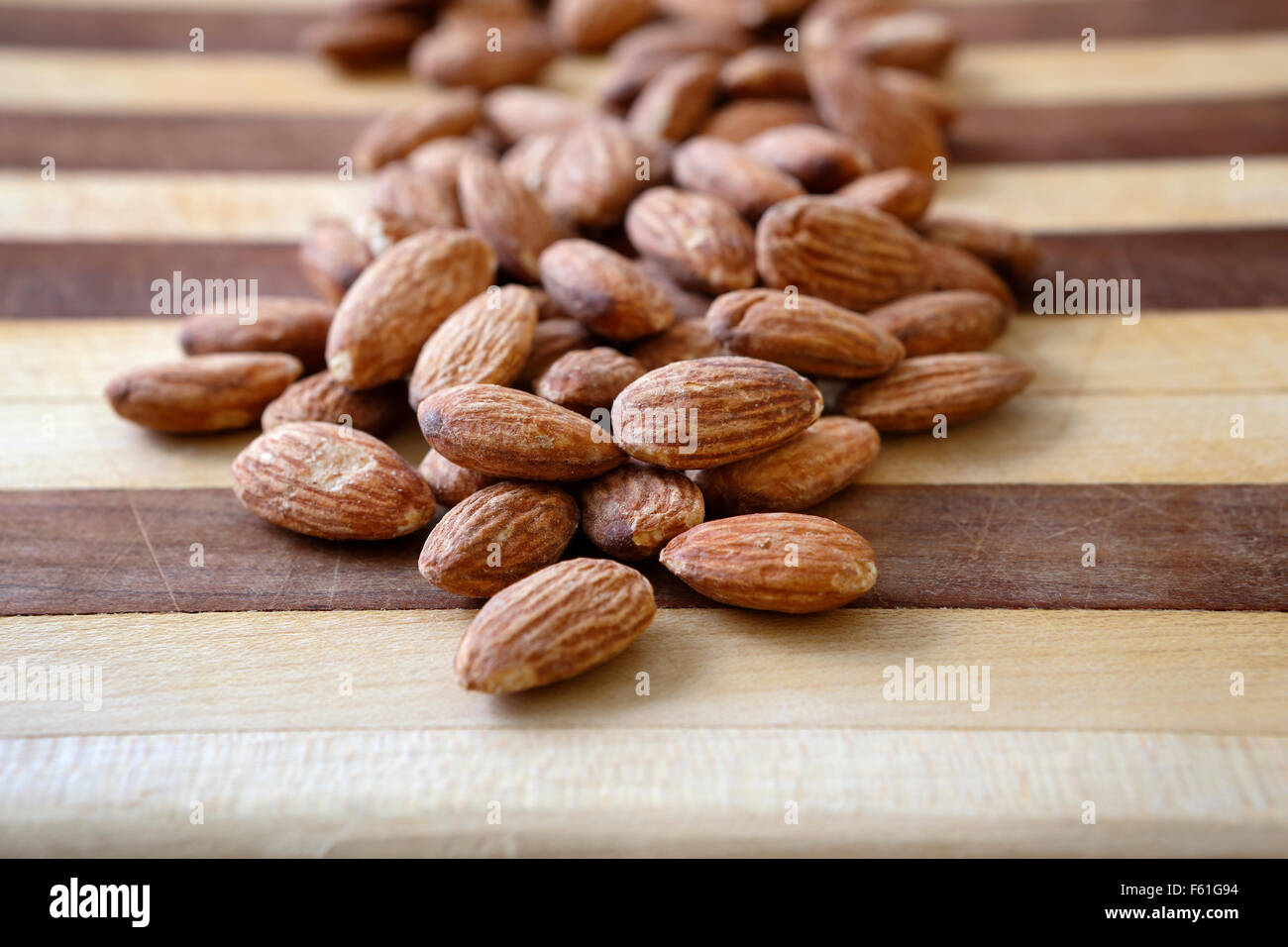 A bunch of almonds on a cutting board ready to become part of a healthy ...