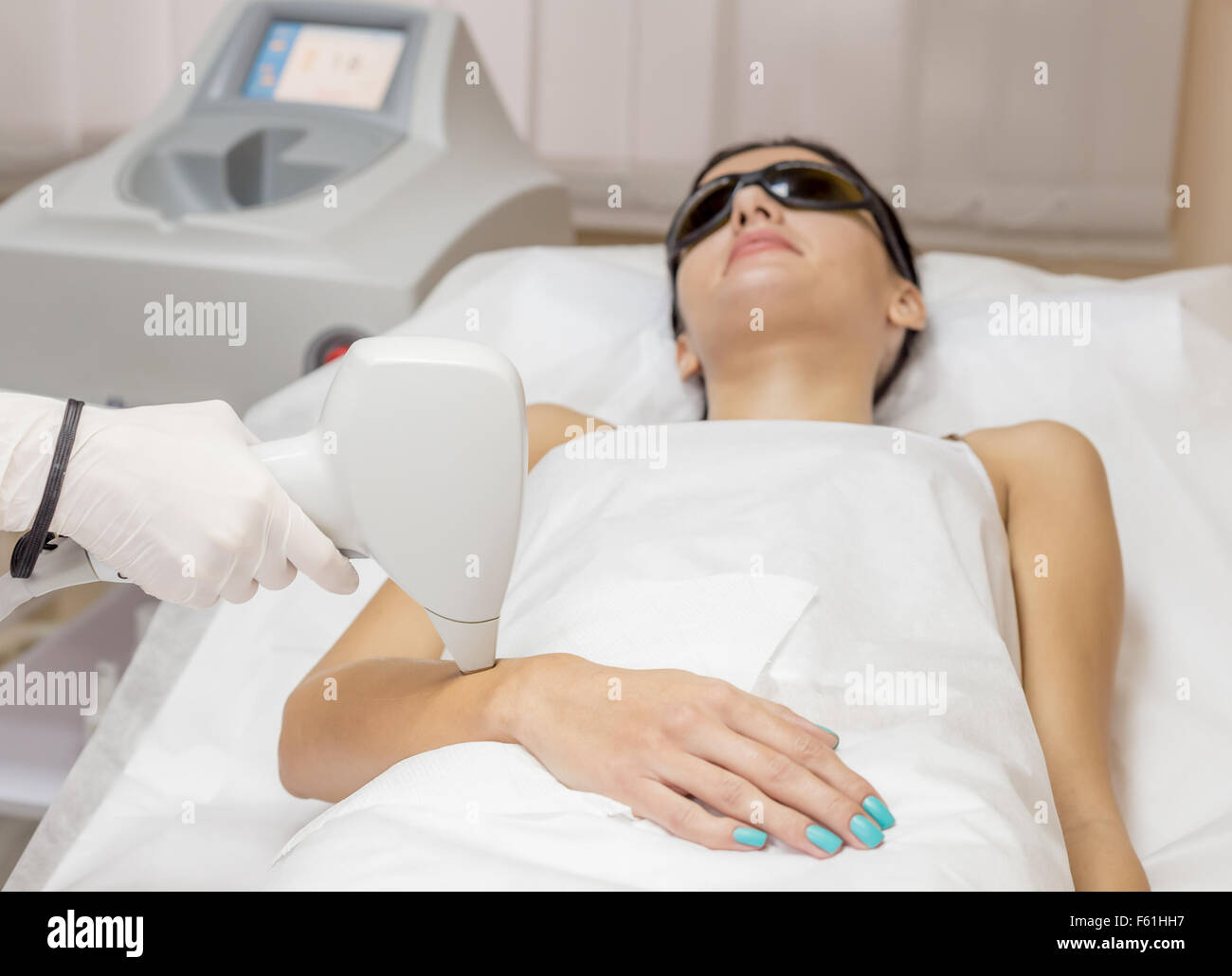 Laser hair removal on ladies hand in beauty salon Stock Photo - Alamy