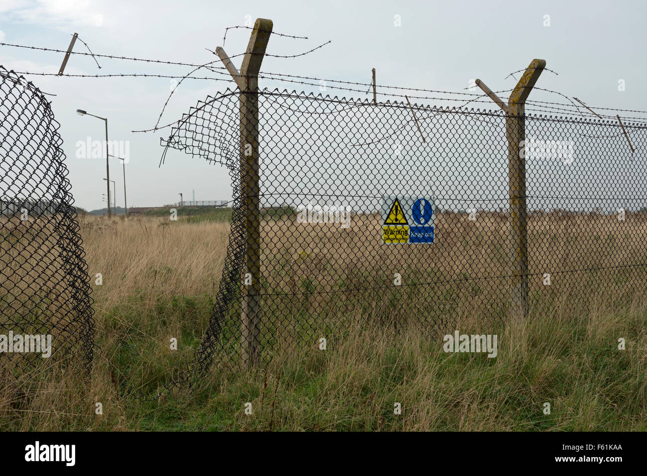 Hole in the fence of a former cold-war radar station, Bawdsey Ferry ...