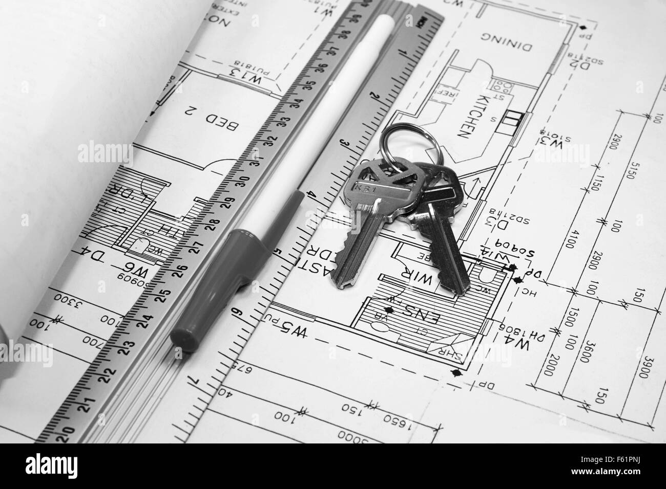 architect drawn plans with keys to property Stock Photo - Alamy