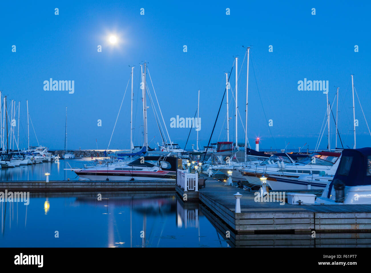 Yachts at the Bronte Outer Harbour Marina at dusk during the full moon ...