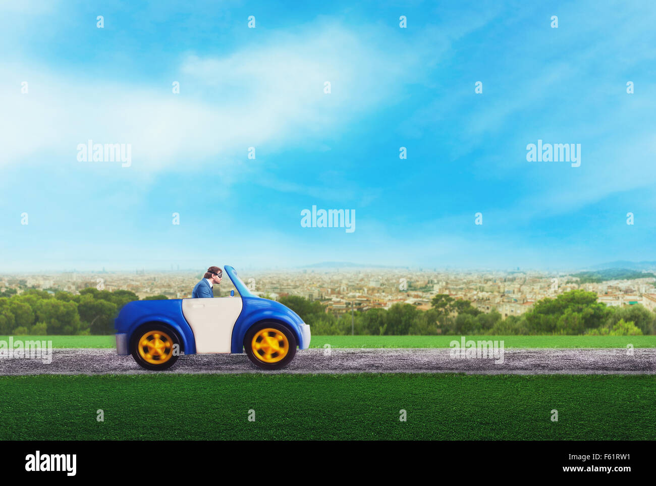 Businessman driving a toy car on the road Stock Photo - Alamy