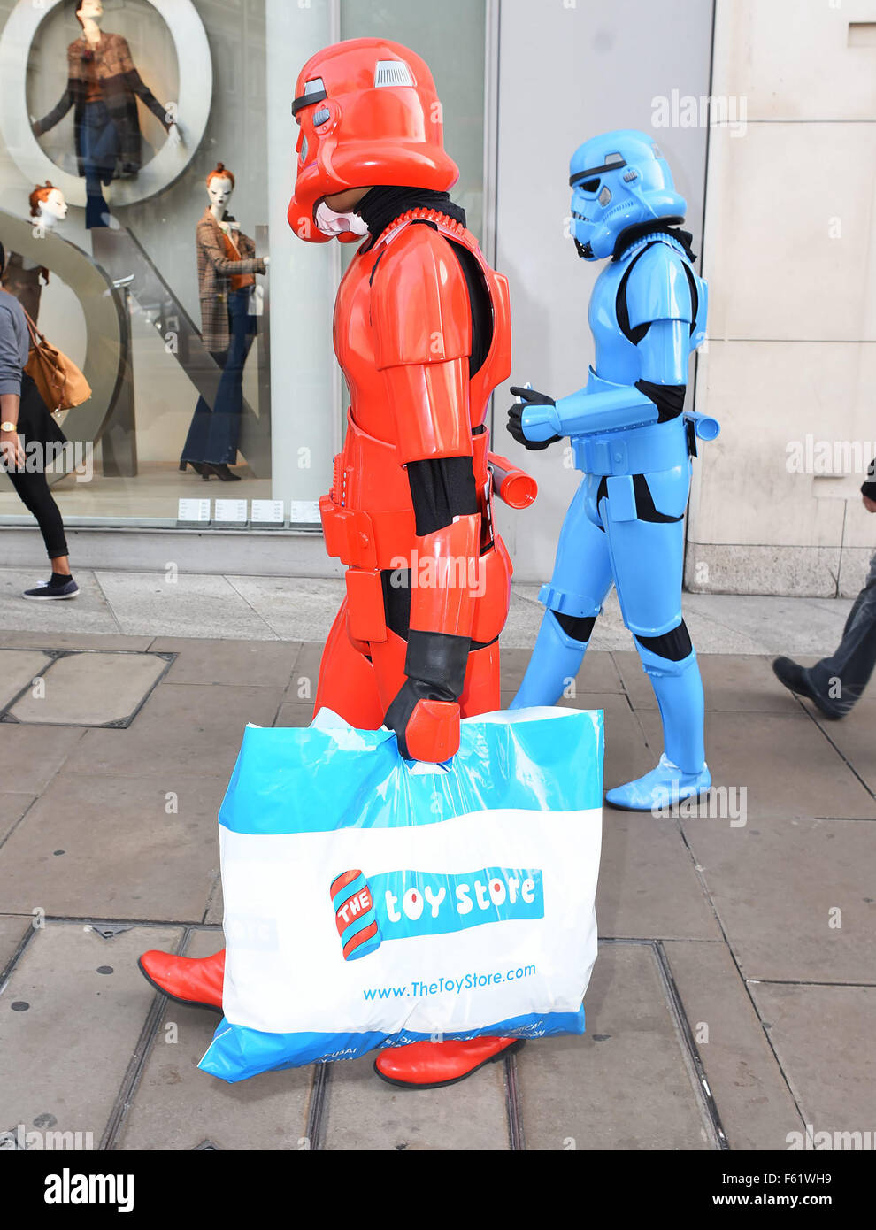 A blue and a red Star Wars Stormtrooper stroll down London's busy ...