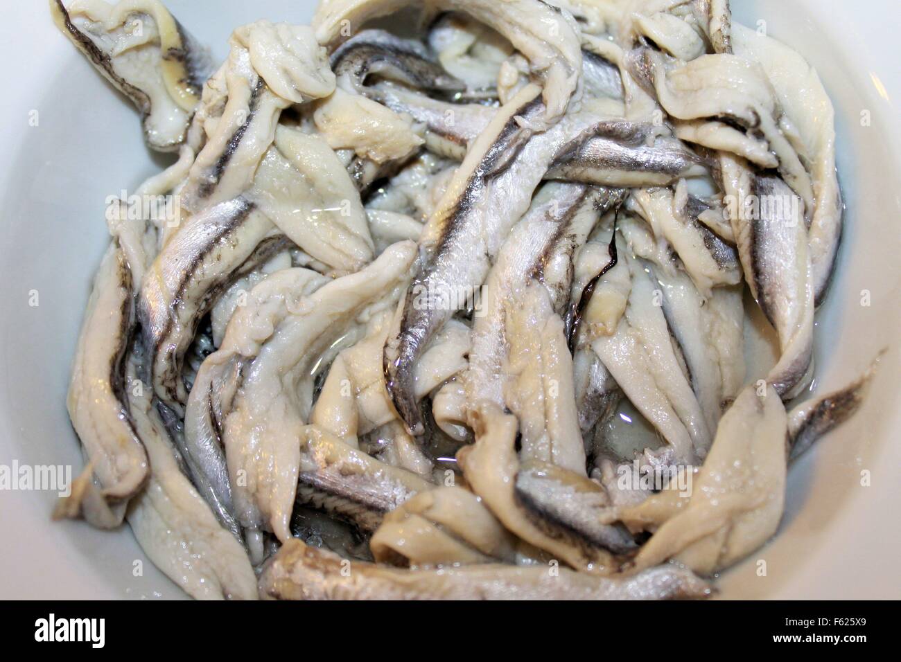 anchovy fillets marinated in small bowl Stock Photo - Alamy