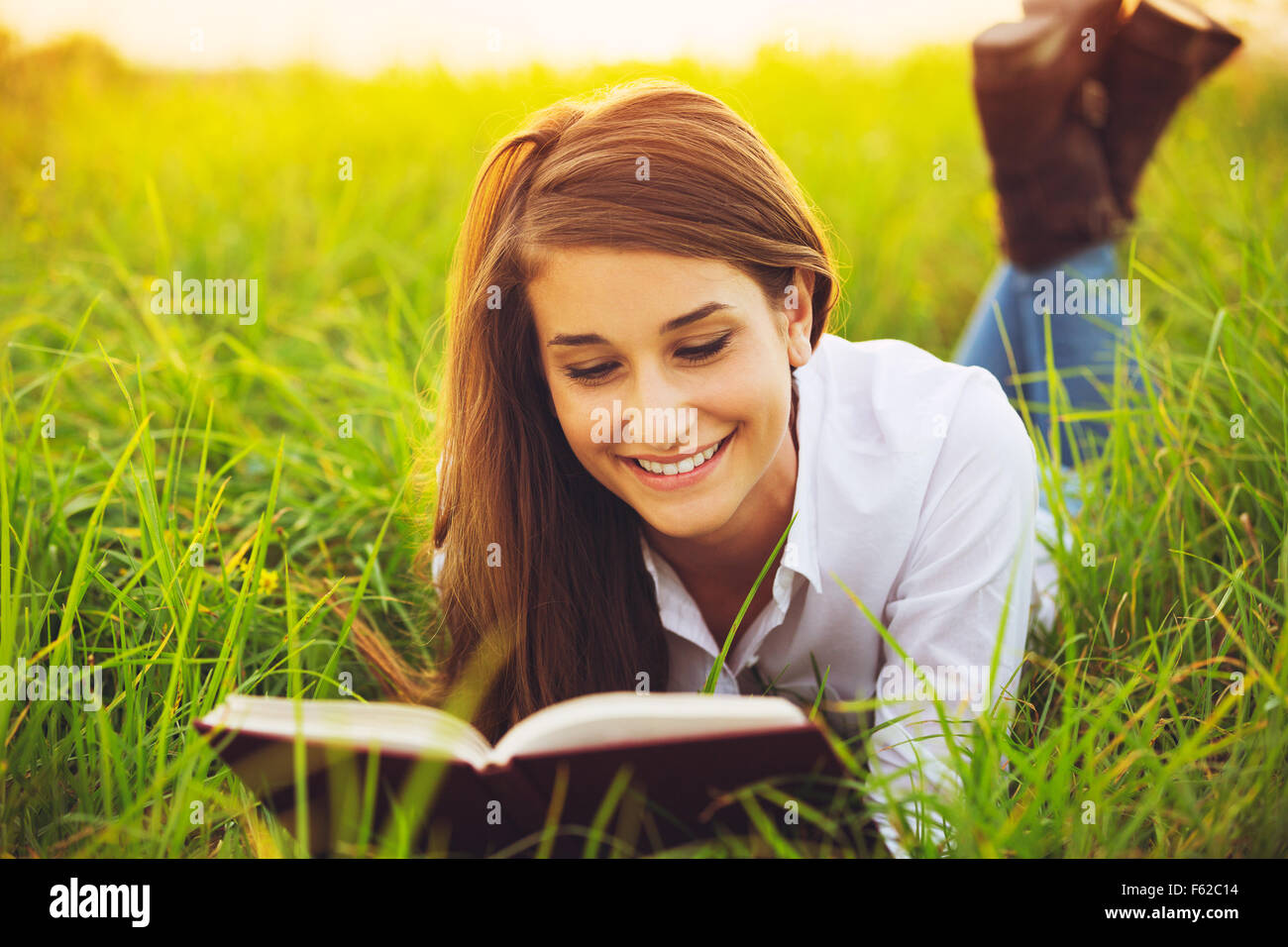 Young Woman Enjoying a Book Reading Outdoors Stock Photo - Alamy