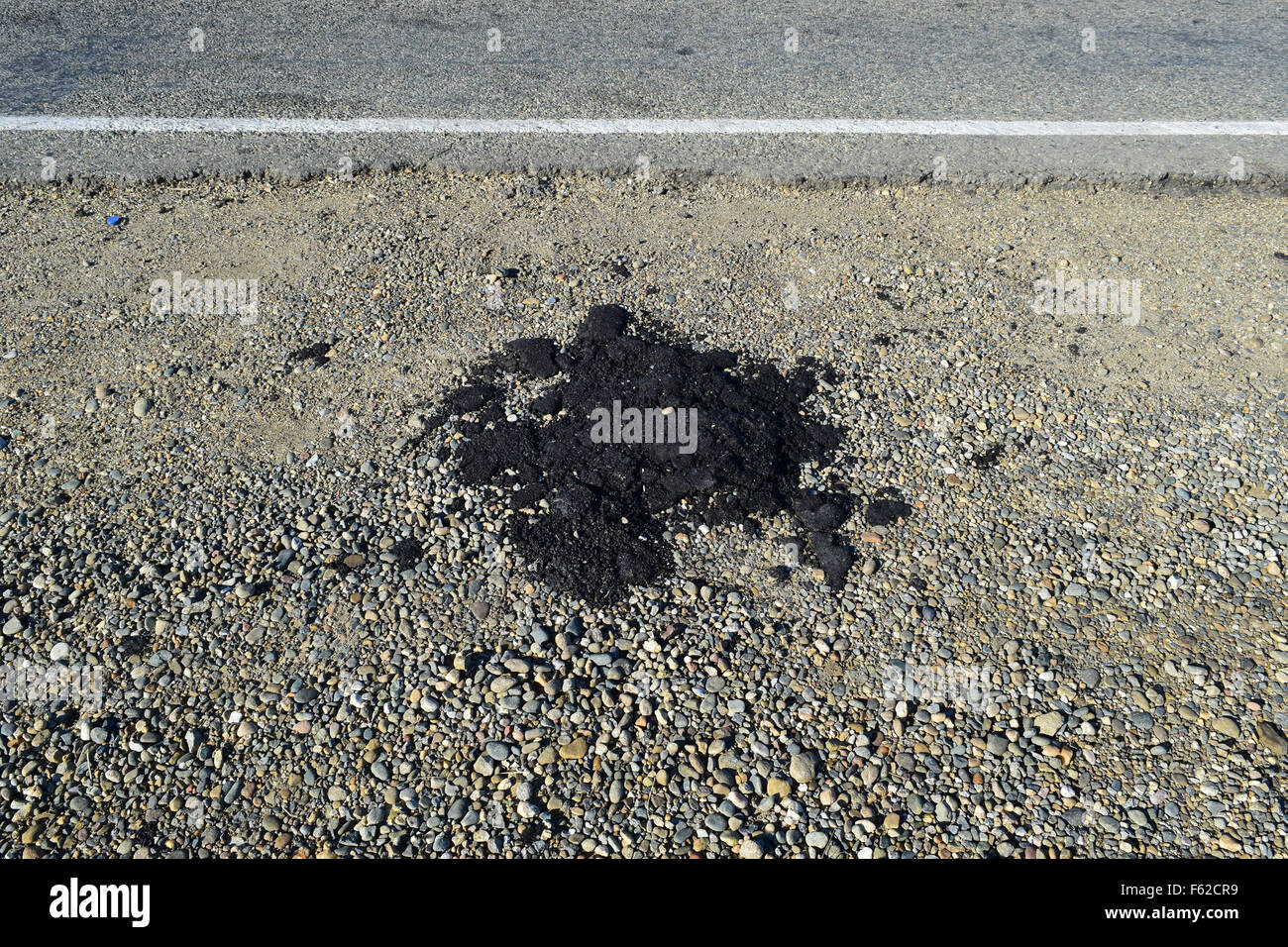 The piece of fresh asphalt which dropped out on a roadside. Repair of ...