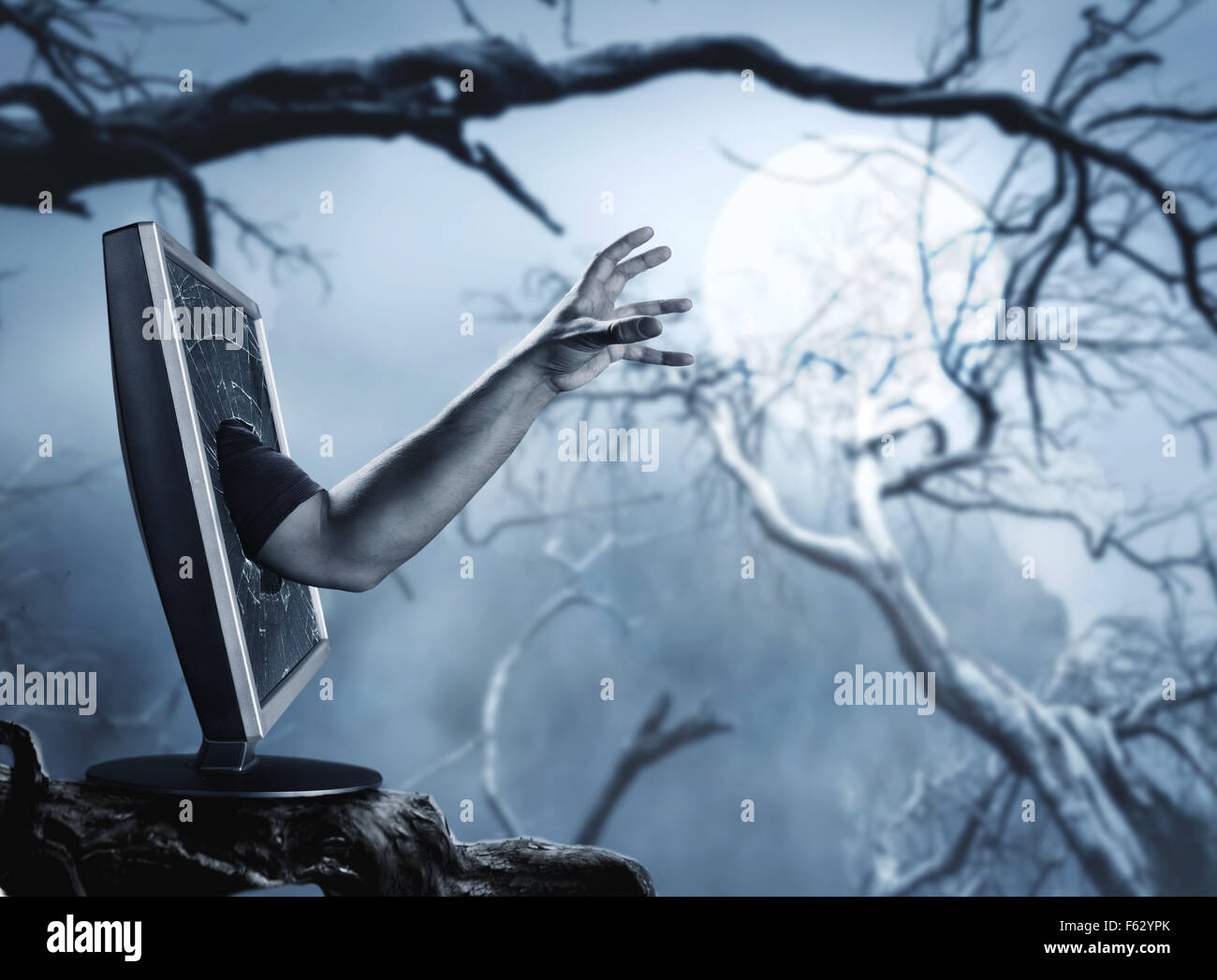 Male hand rising from computer screen in the horrific forest Stock ...