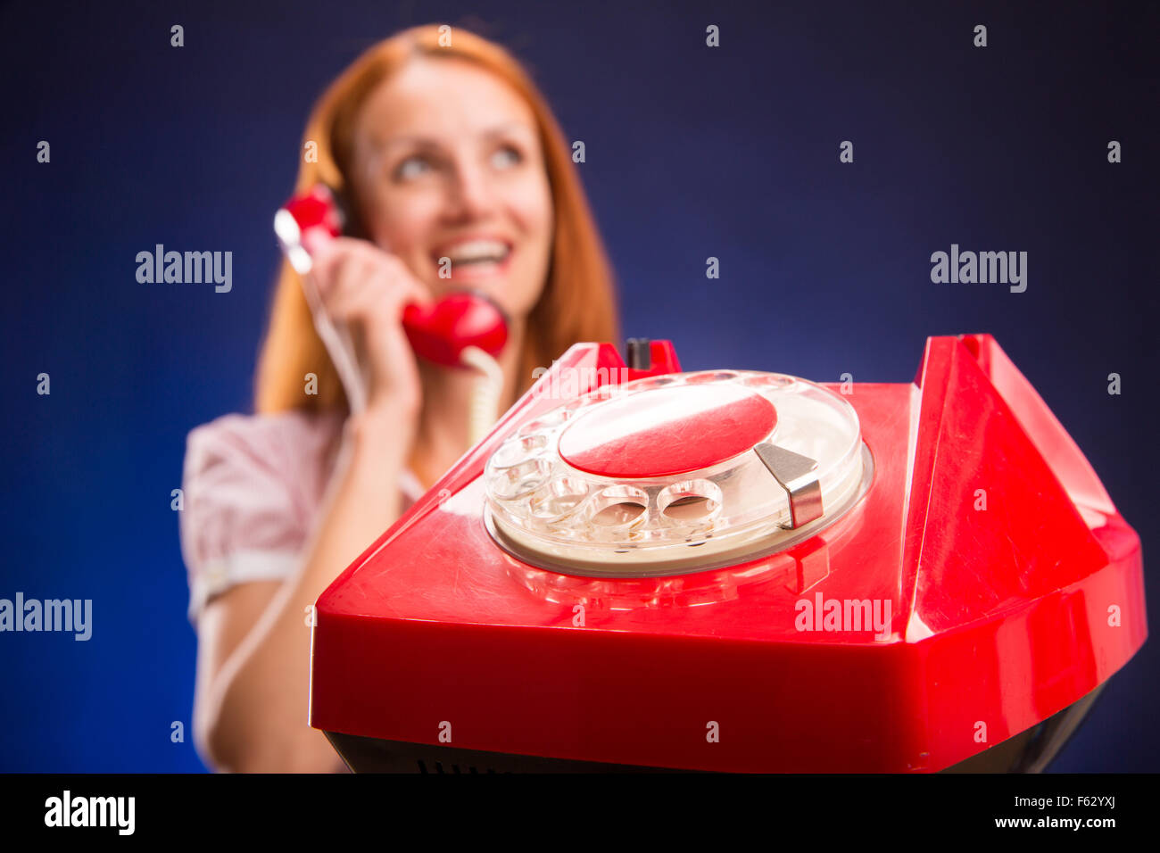 Smiling woman with red telephone Stock Photo - Alamy