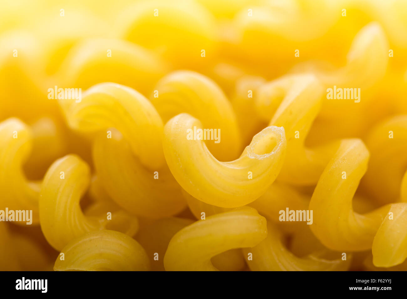 Heap of yellow macaroni. Macro view Stock Photo - Alamy