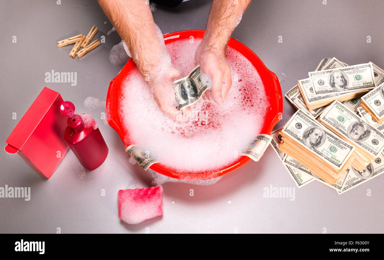 Human is washing dollars banknotes in foam in red washbowl Stock Photo ...
