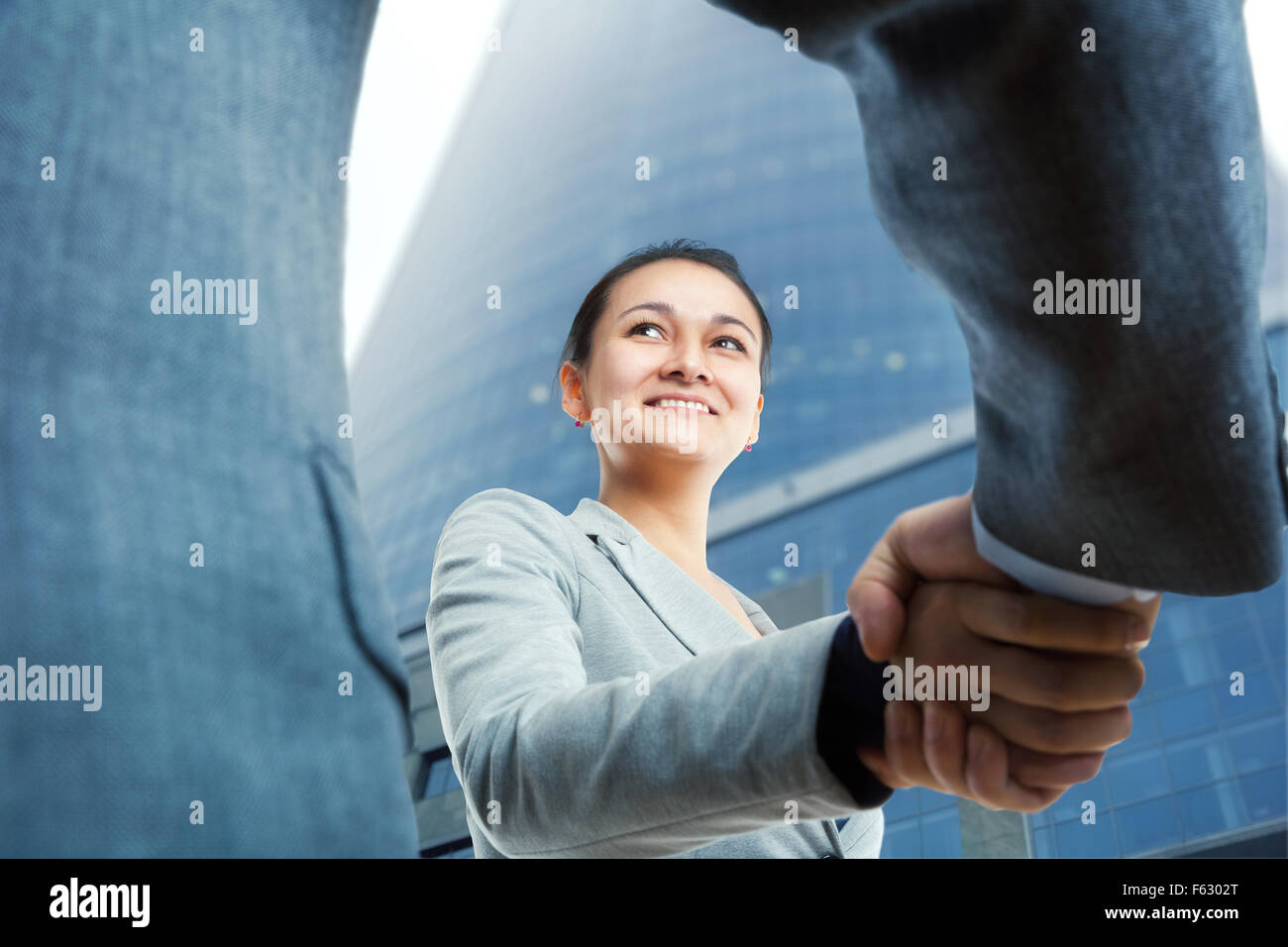 Happy businesswoman and client handshaking Stock Photo - Alamy