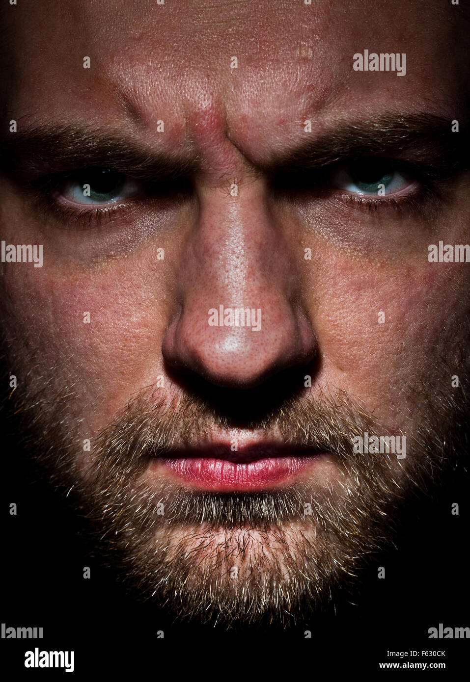 Close-up portrait of angry bearded young man Stock Photo - Alamy