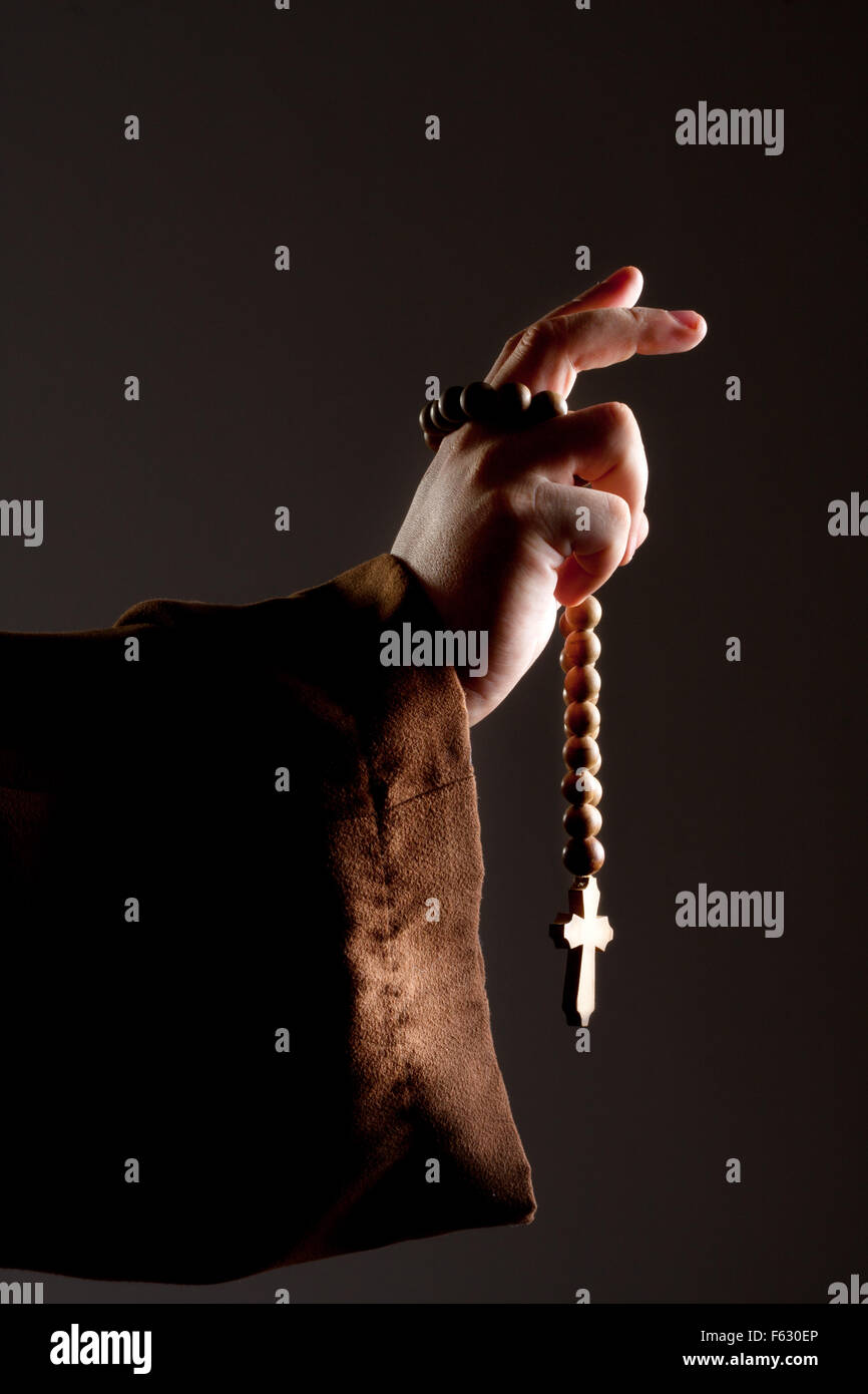 Preaching medieval monk hand with wooden rosary Stock Photo - Alamy