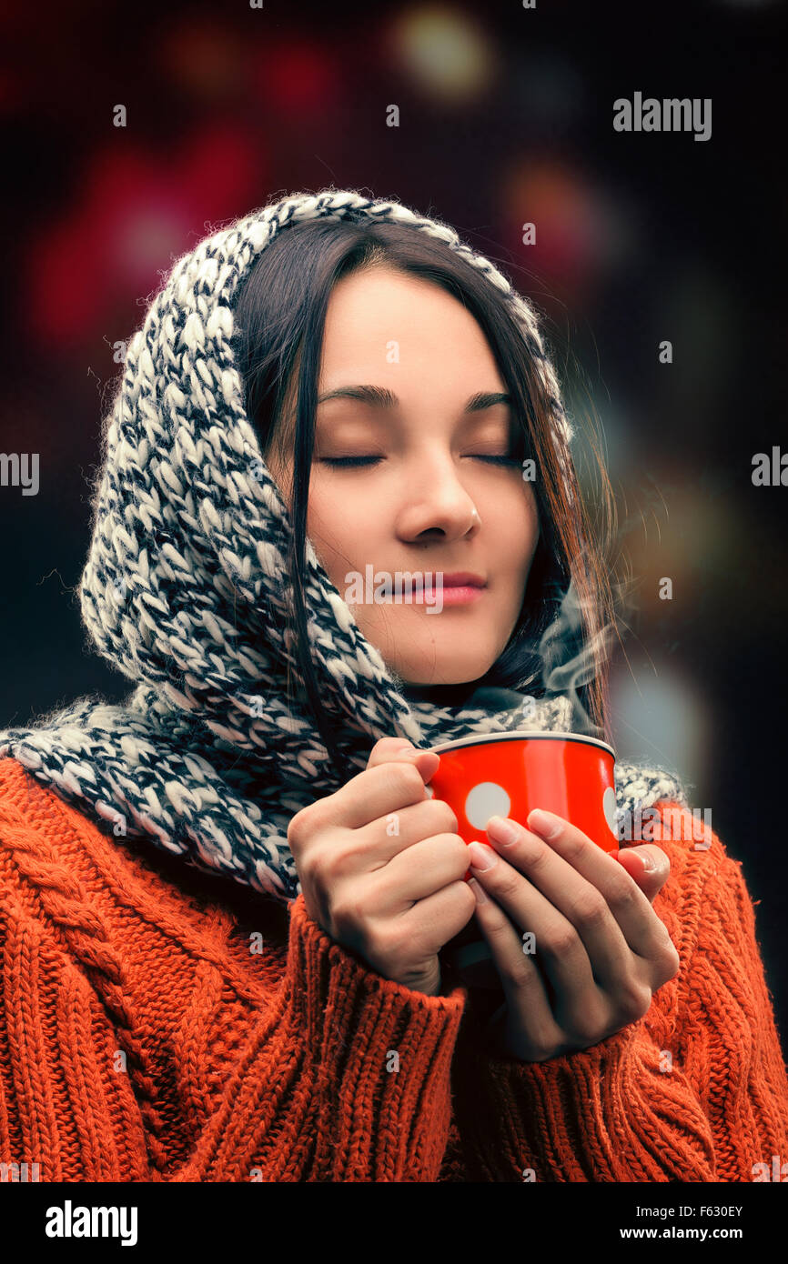 Attractive young lady drinking hot tea Stock Photo - Alamy