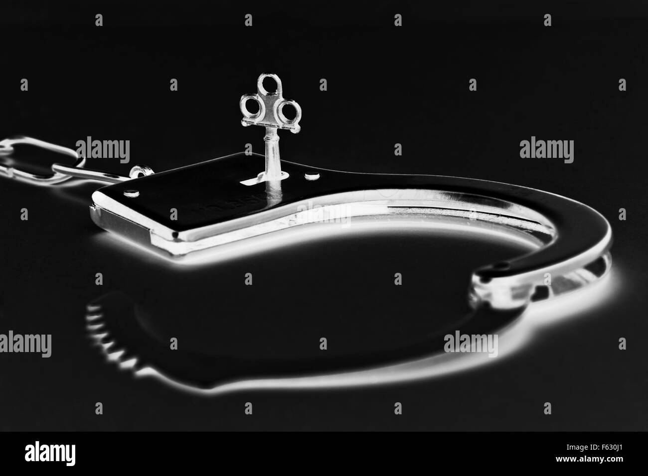 Open handcuffs Black and White Stock Photos & Images - Alamy