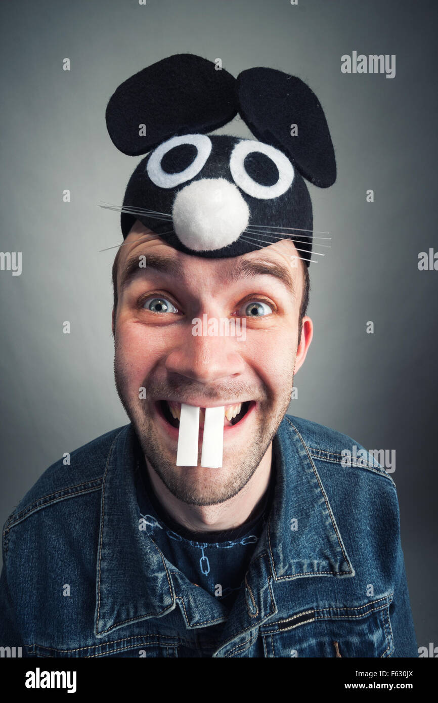 Portrait of strange young man with mouse ears and teeth Stock Photo - Alamy
