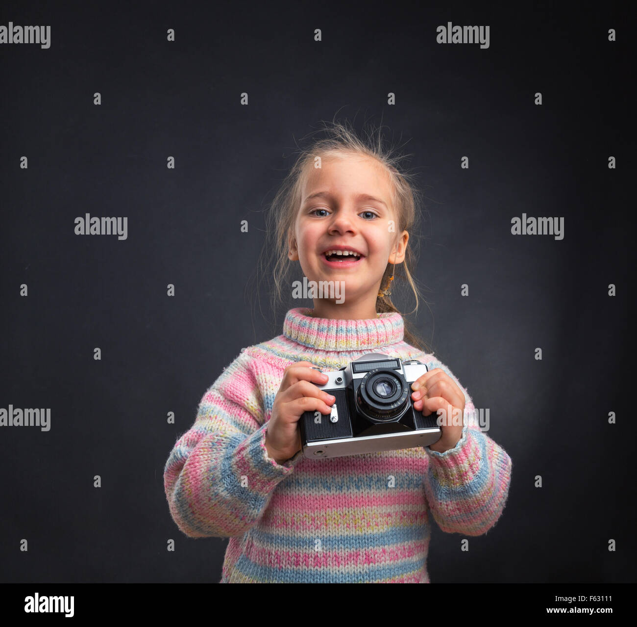 Happy little girl with retro camera on grey Stock Photo - Alamy