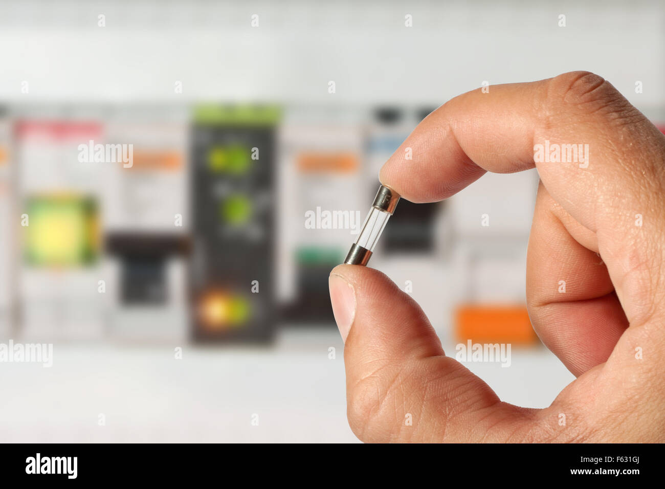 Fuse in electrician hand against control panel Stock Photo - Alamy