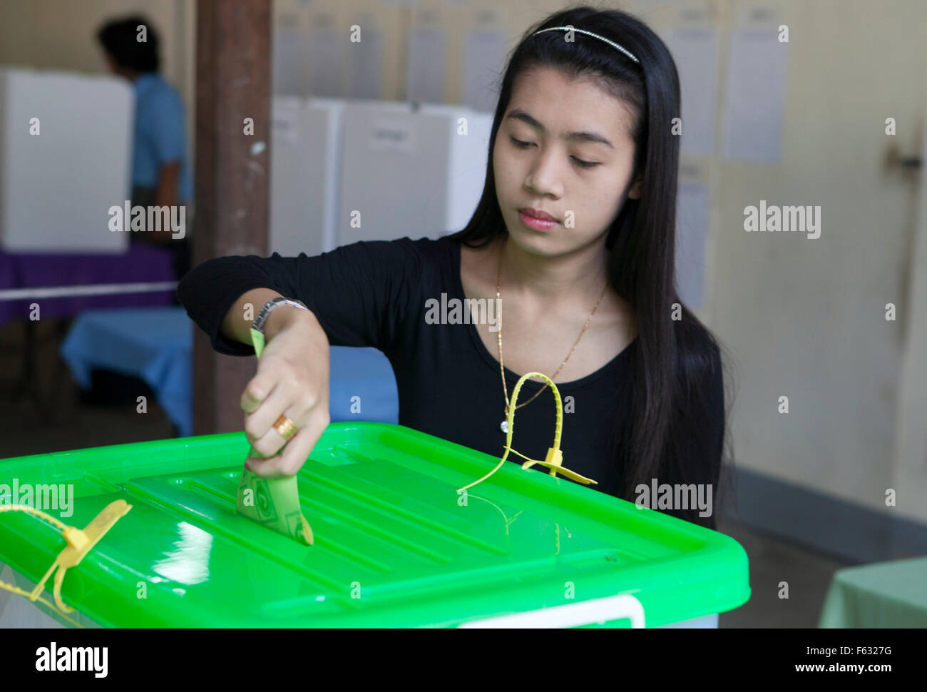 Burmese people vote, at a polling station, during the first general ...
