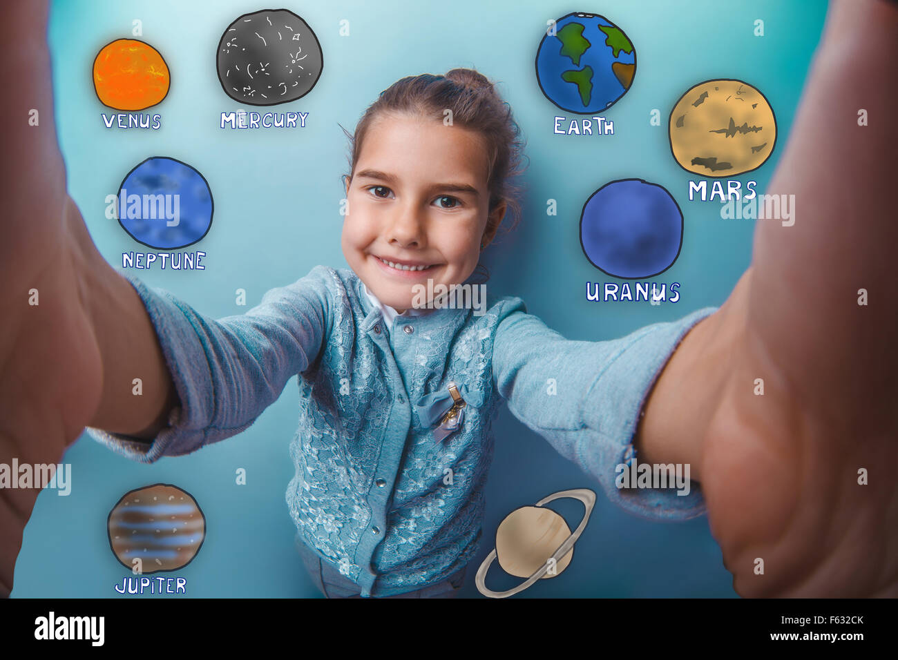 Teen girl smiling and removes self planets of the solar system ...