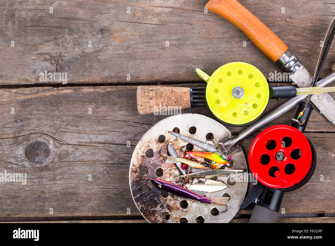 frame from ice fishing rods, tackles and equipment on wooden timber ...