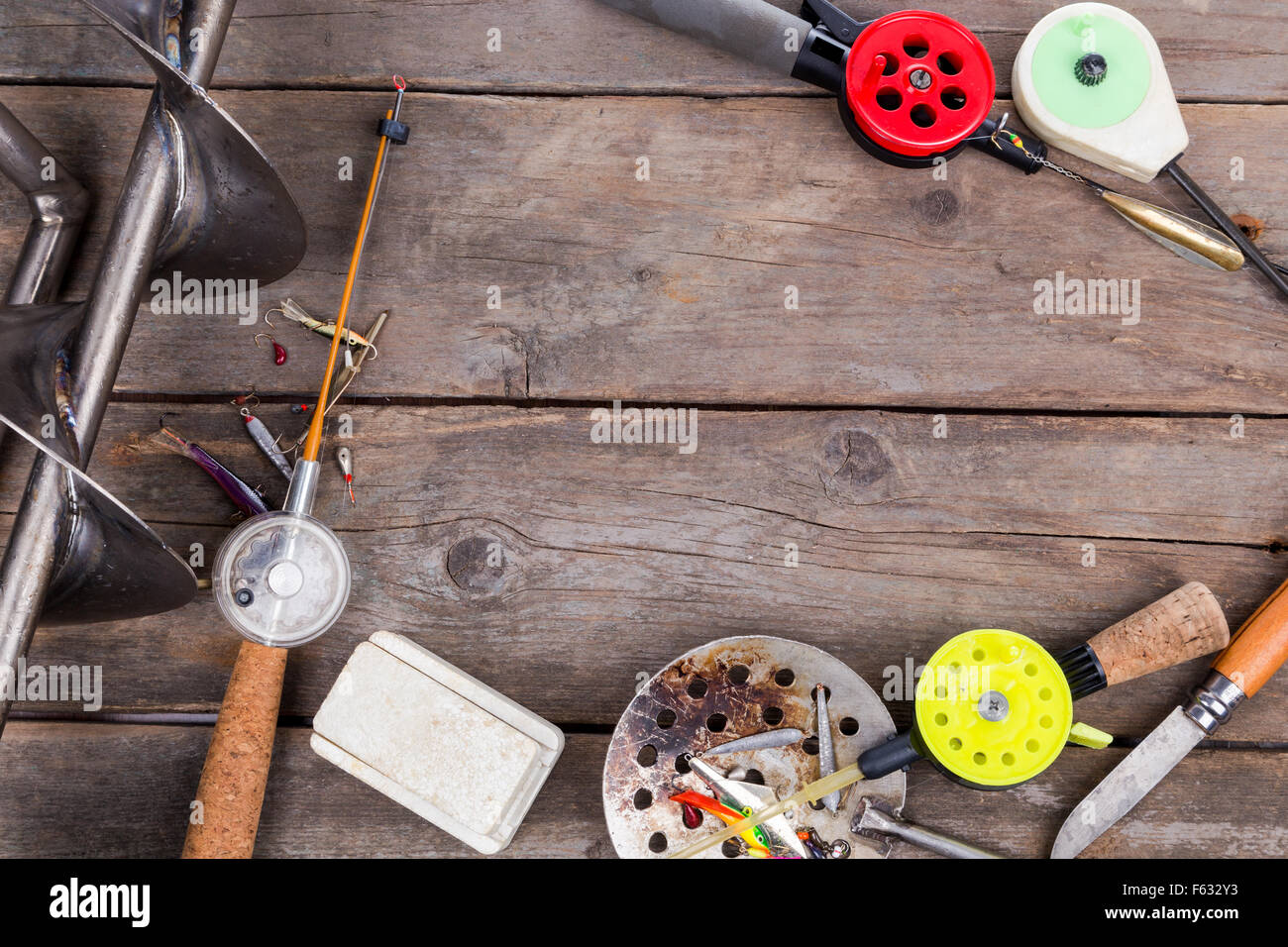 frame from ice fishing rods, tackles and equipment on wooden timber ...