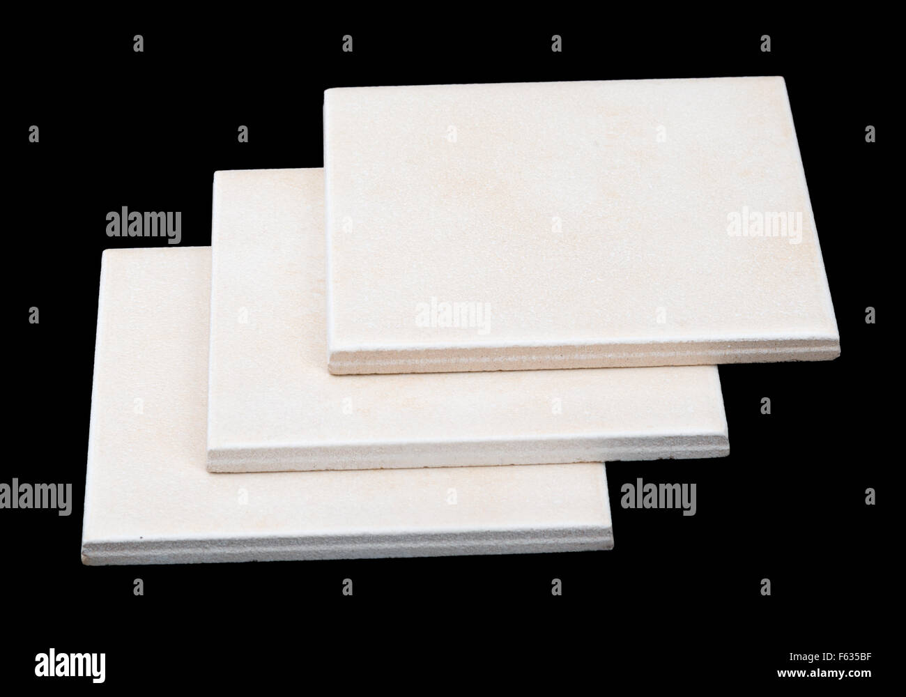 Pile of tiles on black background, side view Stock Photo - Alamy