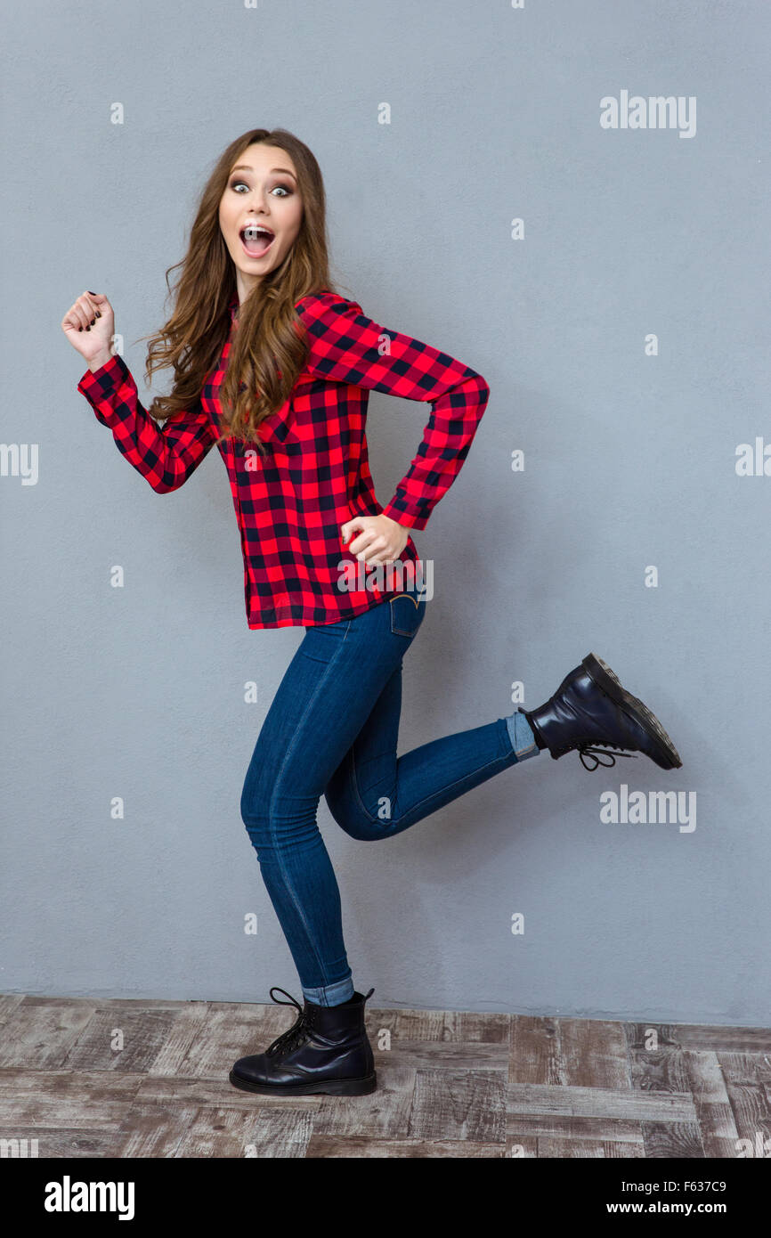 Funny pretty emotional exciting girl in checkered shirt running Stock ...
