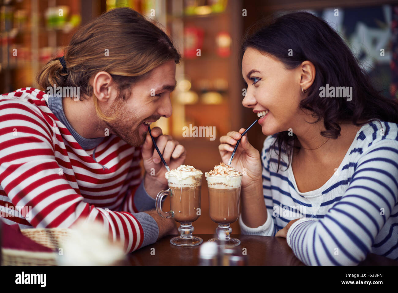 Young couple drinking coffee together in a cafe Stock Photo - Alamy