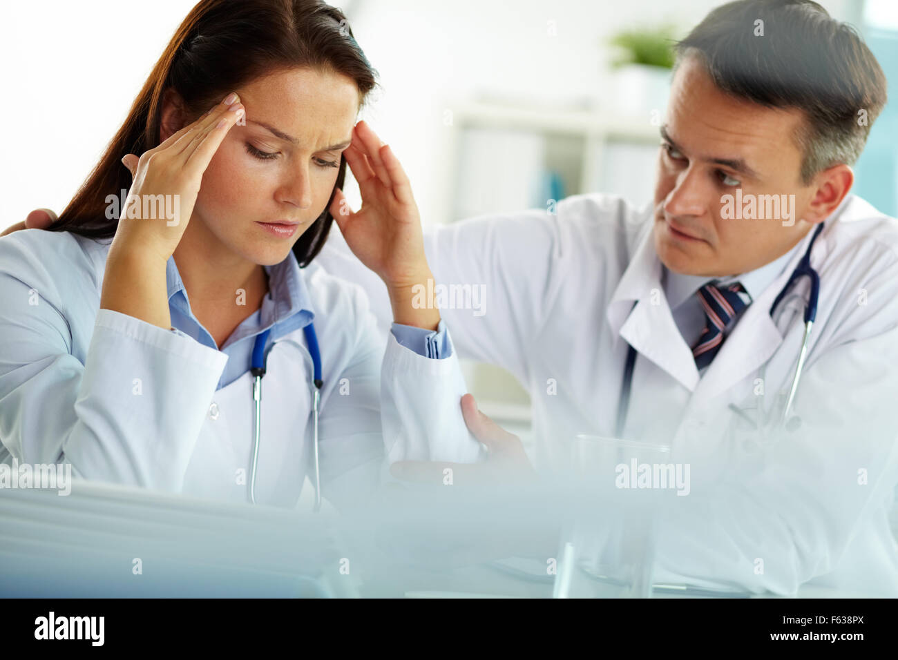 Doctor comforting his upset colleague Stock Photo - Alamy