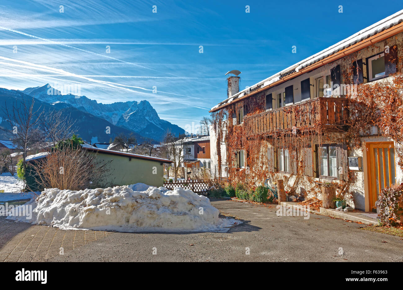 View of enchanting upper Bavarian-styled building covered with bright ...