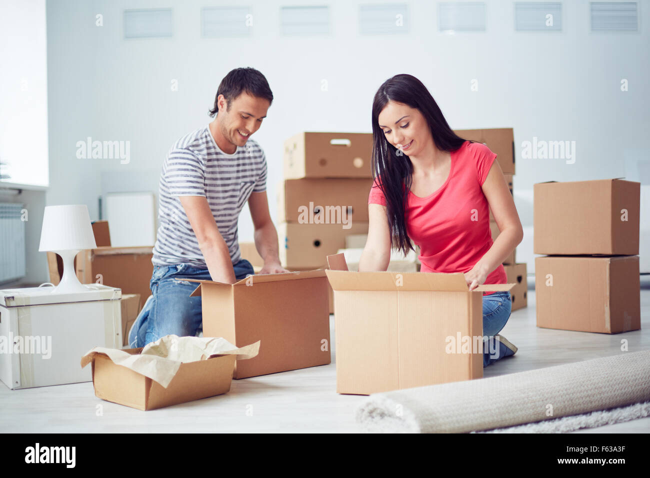 Young couple unpacking boxes hi-res stock photography and images - Alamy