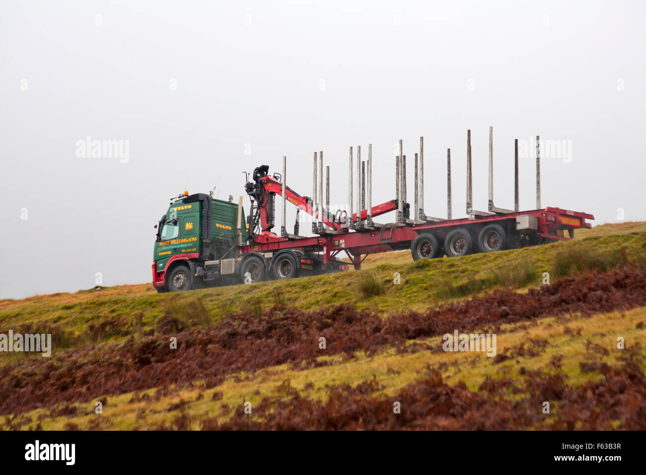 Empty truck used for carrying timber driving past near Llyn Brianne ...