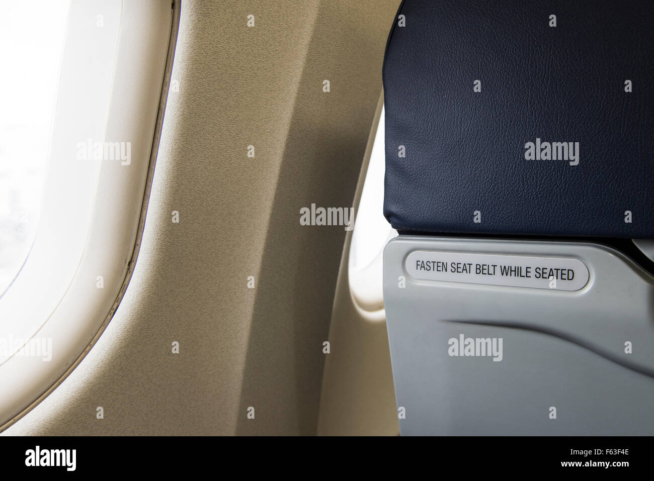 'Fasten seat belt while seated' in airplane Stock Photo - Alamy